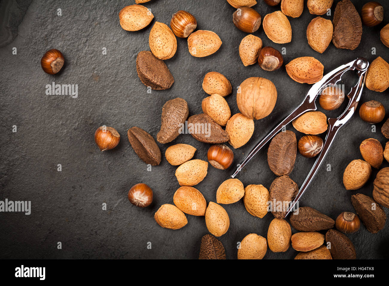 Assortment of nuts on dark slate background Stock Photo - Alamy