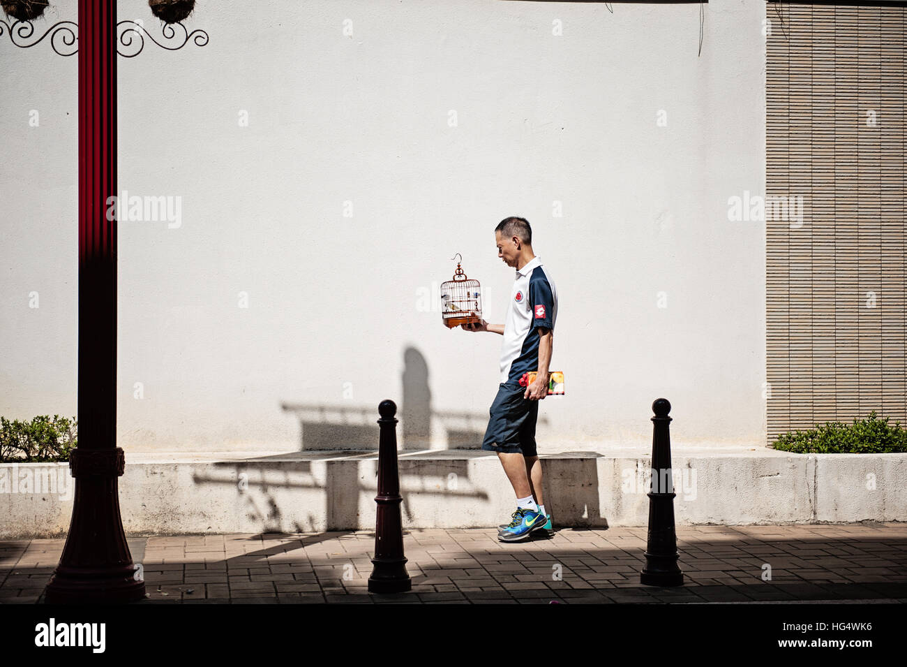 Man carrying bird cage hi-res stock photography and images - Alamy