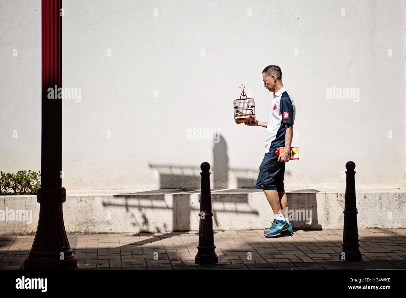 Man carrying bird cage hi-res stock photography and images - Alamy
