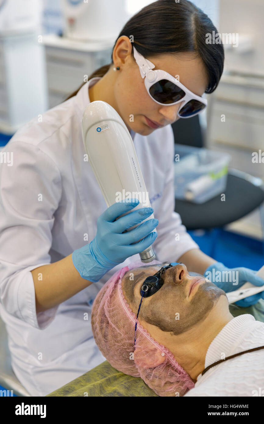 Unrecognized young woman cosmetology therapist demonstrates ...