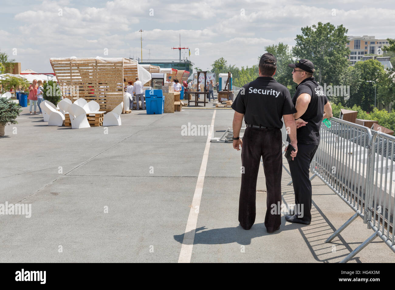 Unrecognized security guards on duty in outdoor food court at Kyiv Wine ...
