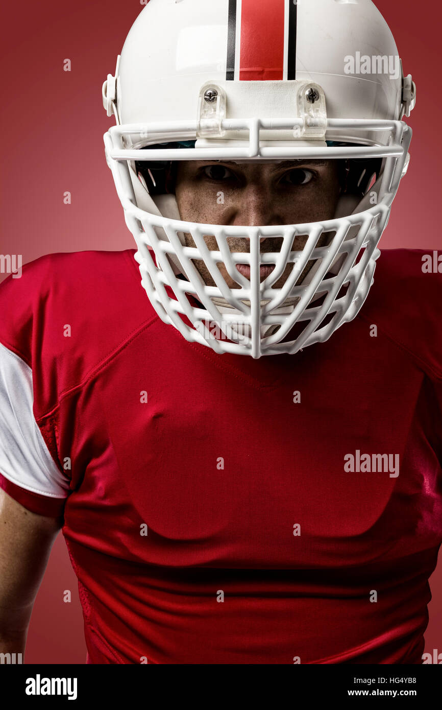 Close up of a Football Player with a red uniform on a red background ...