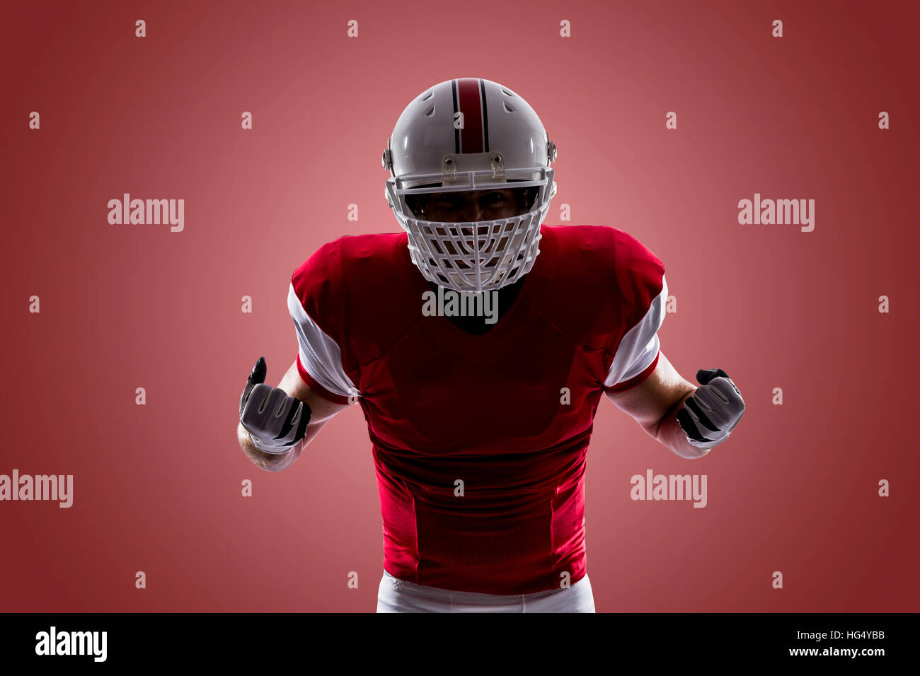 Football Player with a red uniform on a red background Stock Photo - Alamy