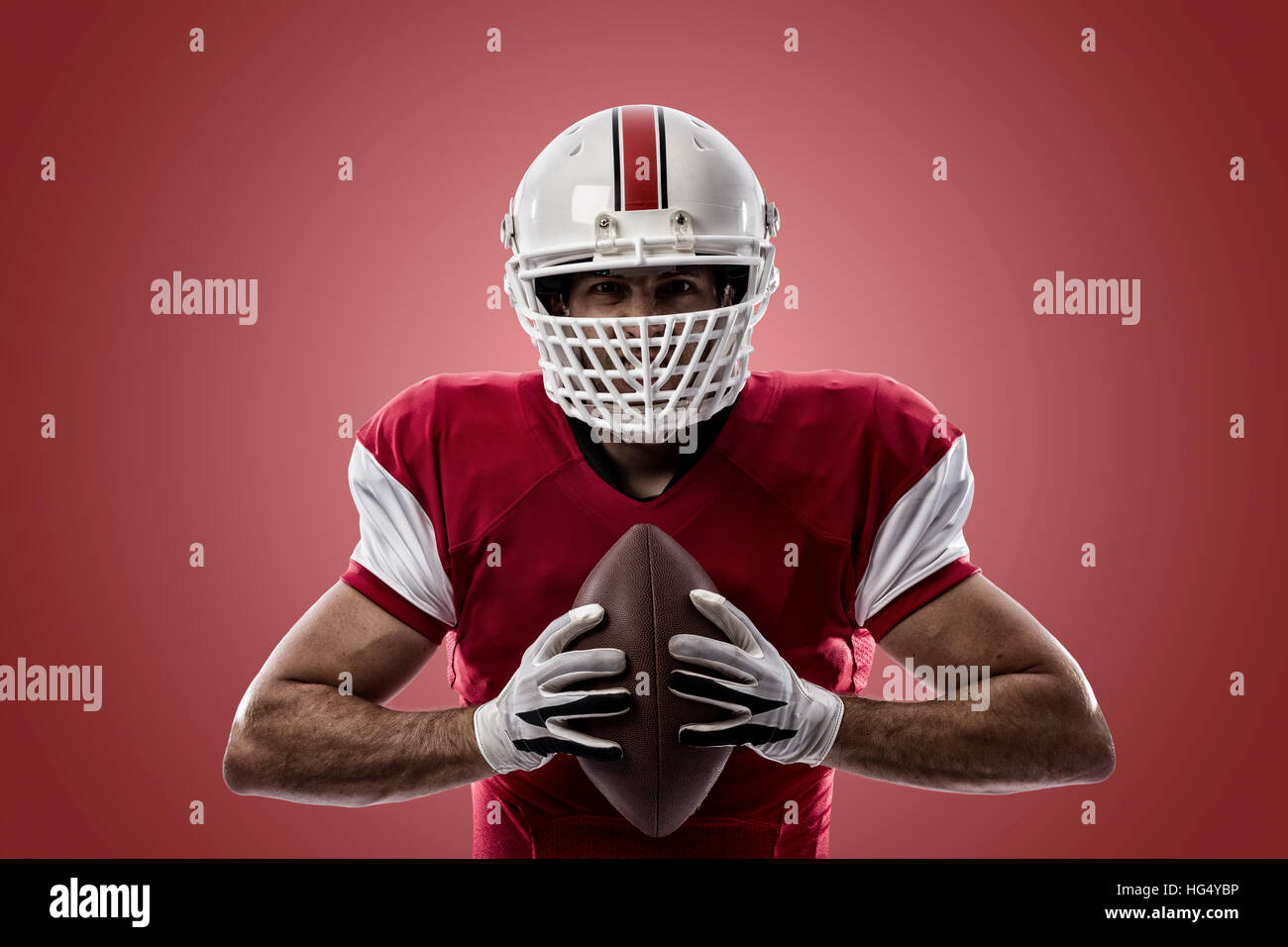 Football Player with a red uniform on a red background Stock Photo - Alamy