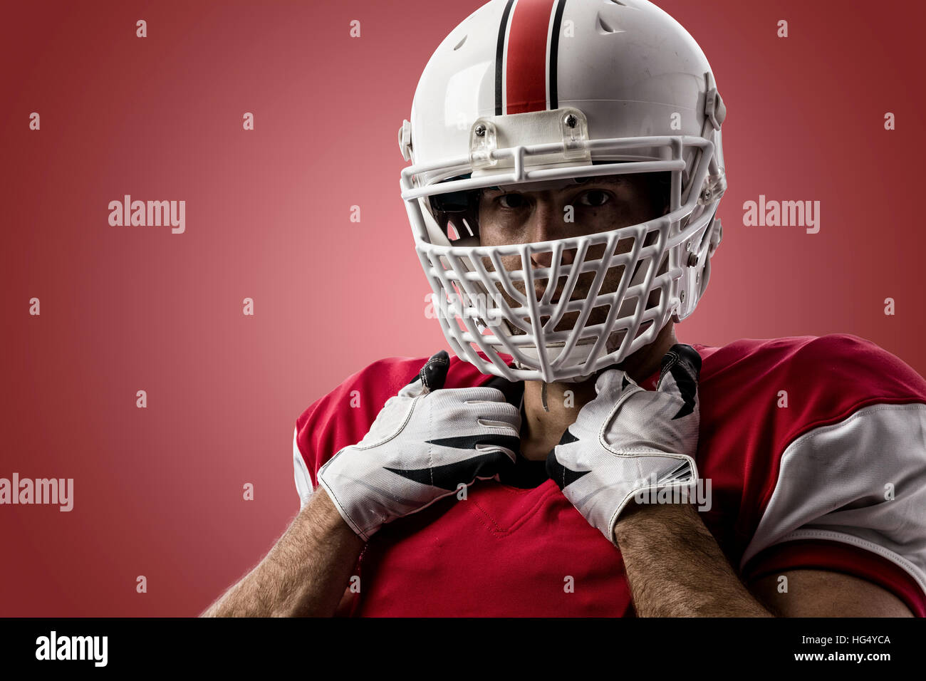Football Player with a red uniform on a red background Stock Photo - Alamy