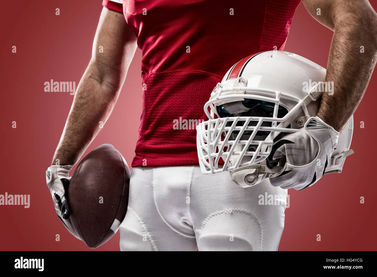 Football Player with a red uniform on a red background Stock Photo - Alamy