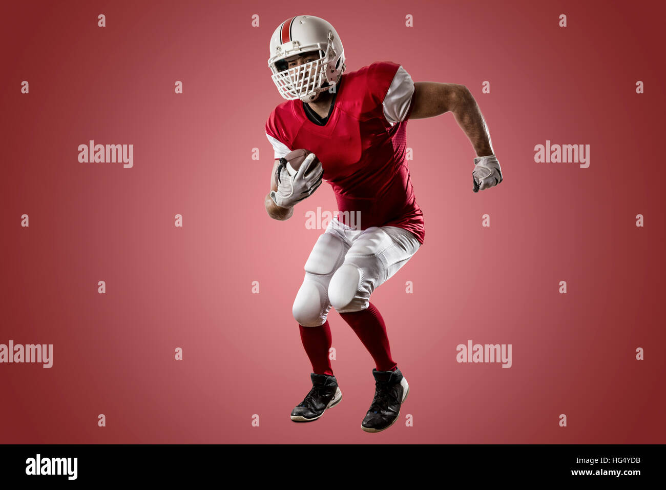 Football Player with a red uniform Running on a red background Stock ...