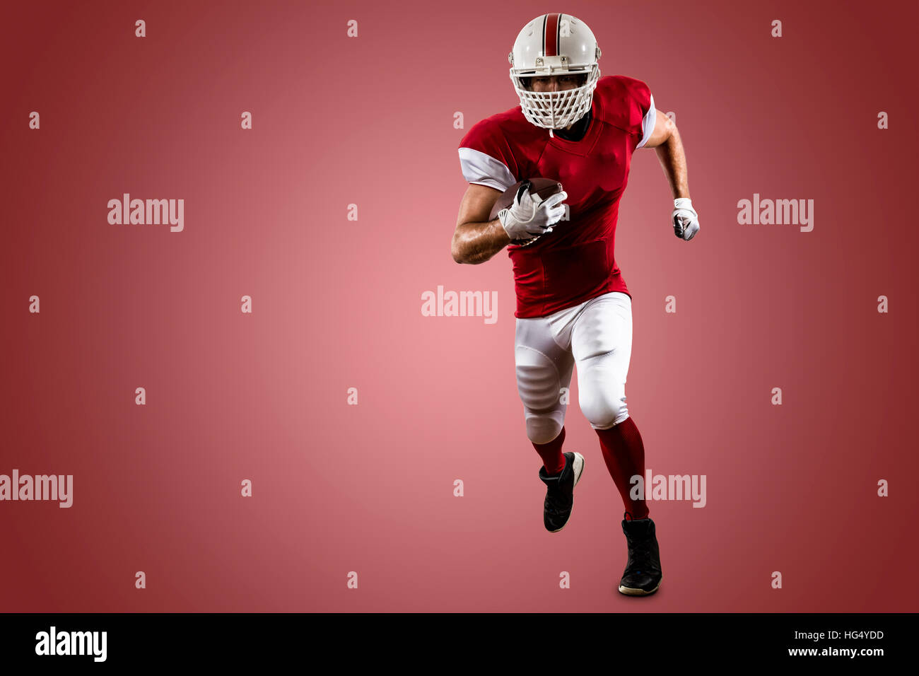 Football Player with a red uniform Running on a red background Stock ...
