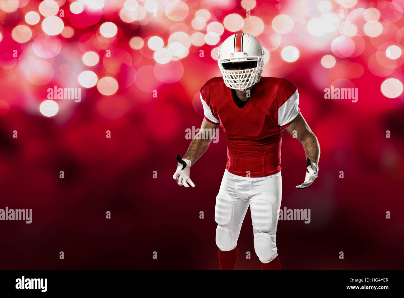 Football Player with a red uniform on a red lights background Stock ...