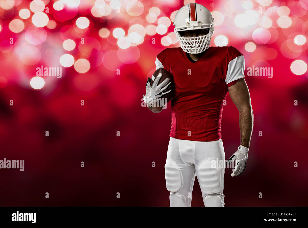 Football Player with a red uniform on a red lights background Stock ...