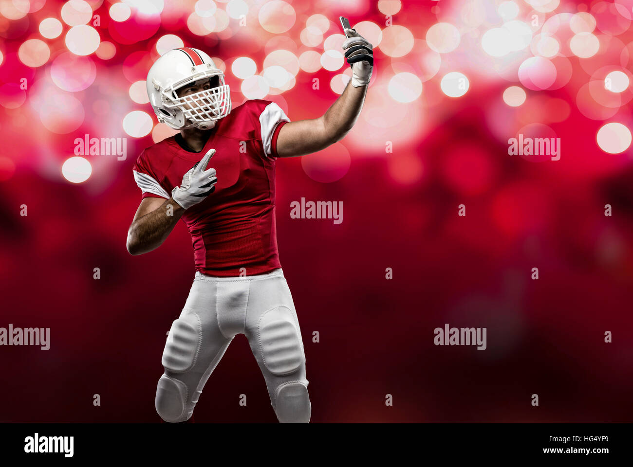 Football Player with a red uniform making a selfie on a red lights ...