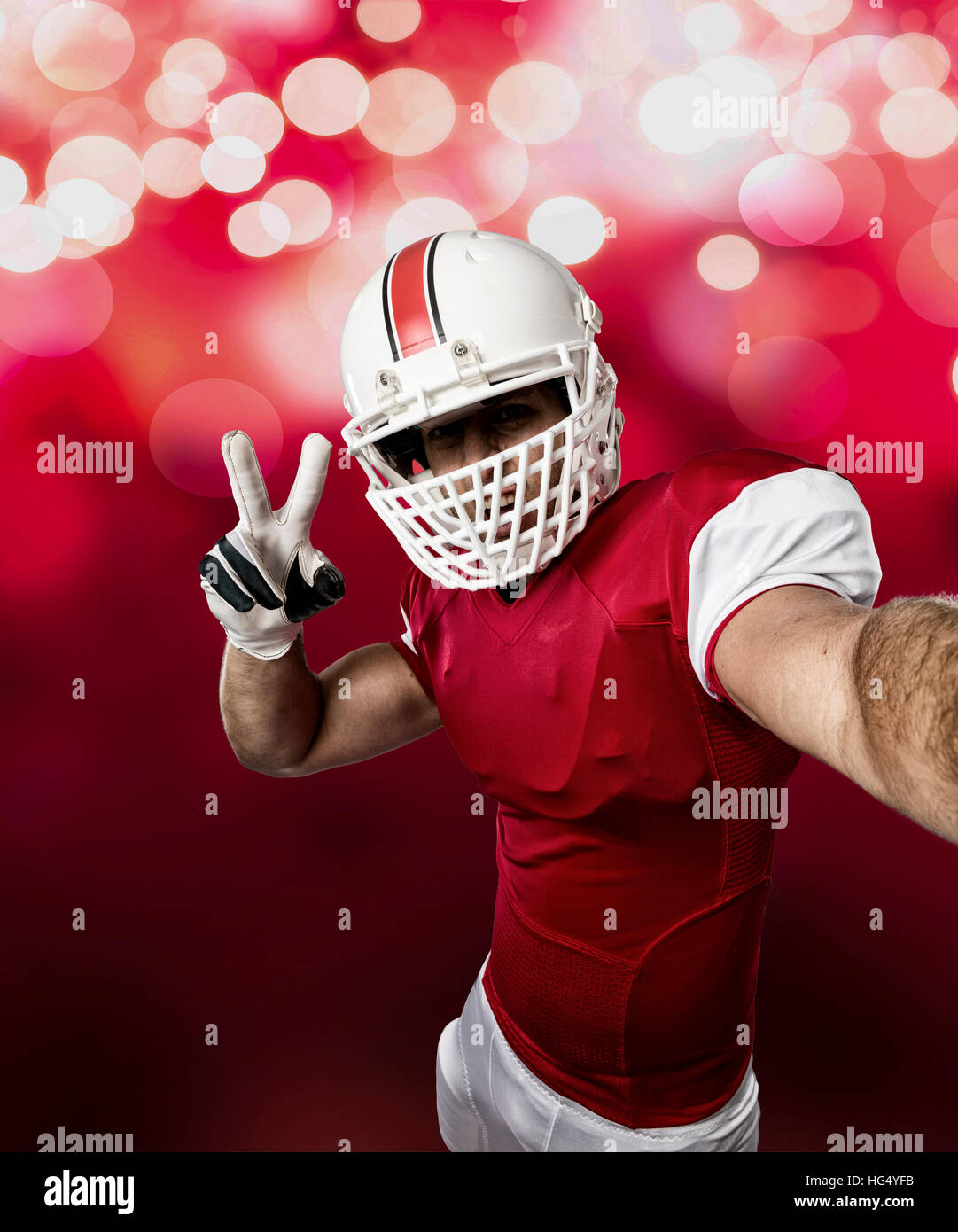 Football Player with a red uniform making a selfie on a red lights ...