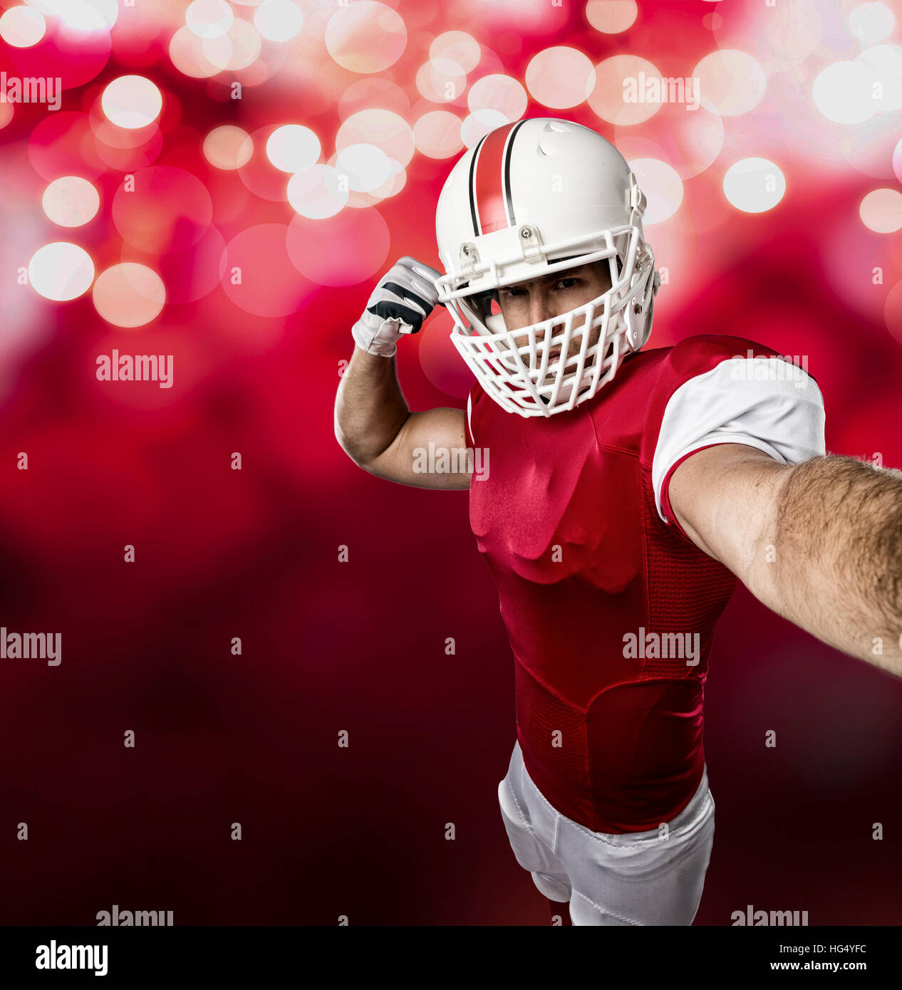 Football Player with a red uniform making a selfie on a red lights ...