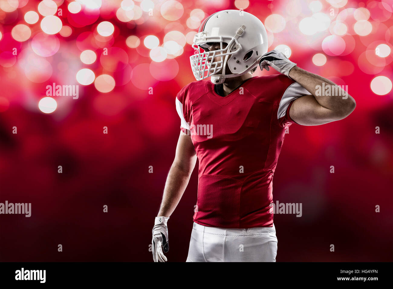 Football Player with a red uniform on a red lights background Stock ...