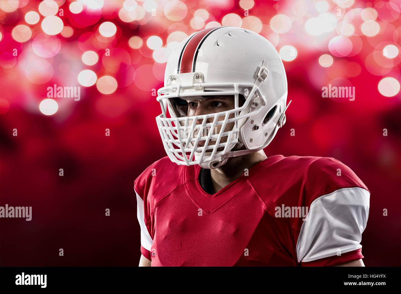 Close up of a Football Player with a red uniform on a red lights ...