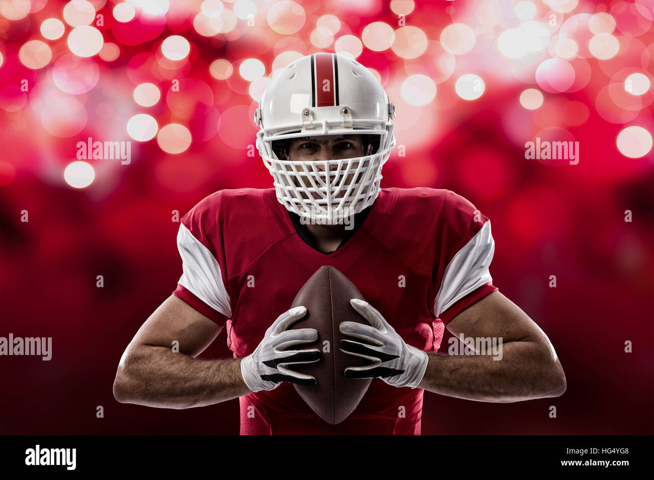 Football Player with a red uniform on a red lights background Stock ...