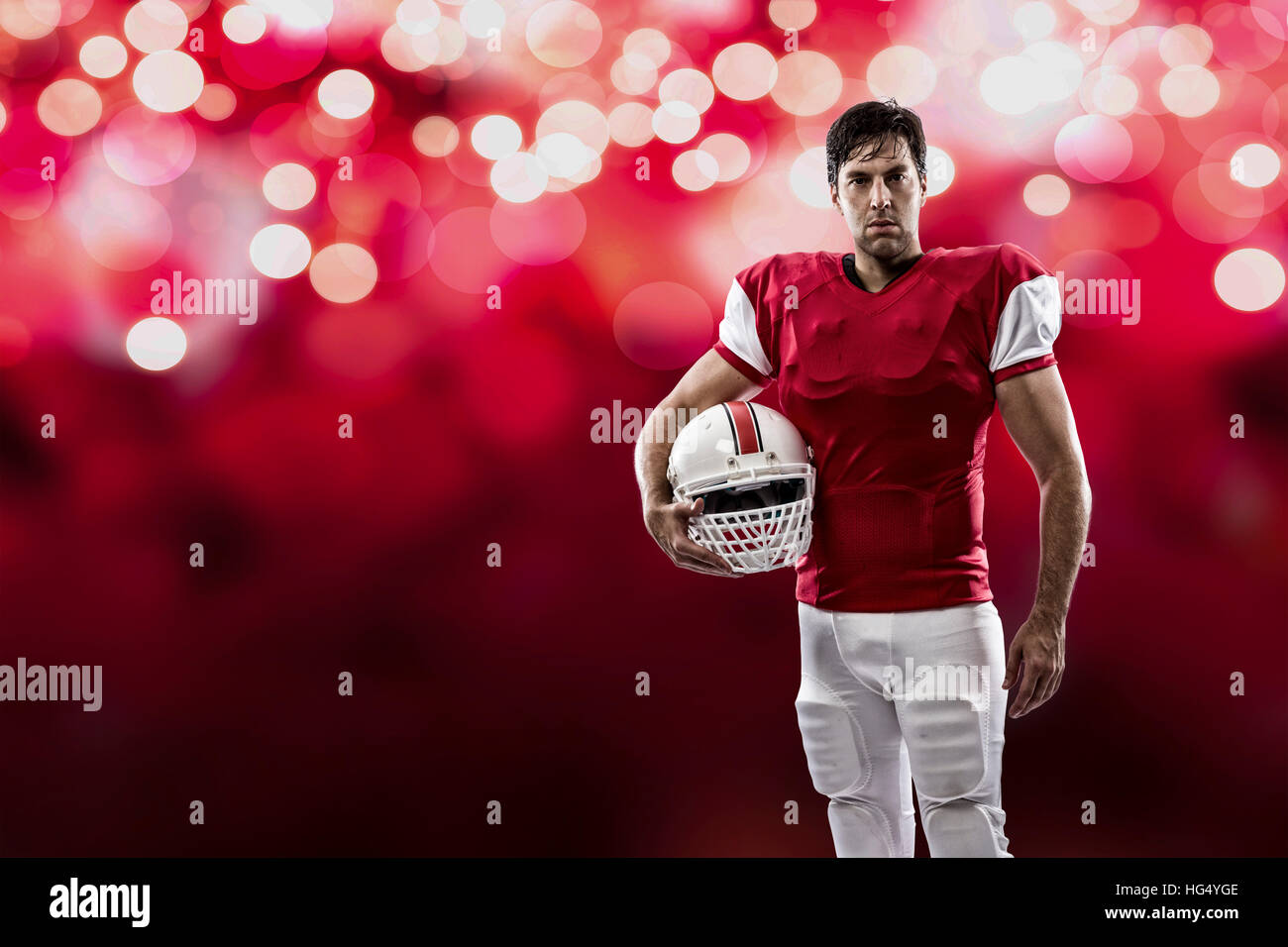Football Player with a red uniform on a red lights background Stock ...