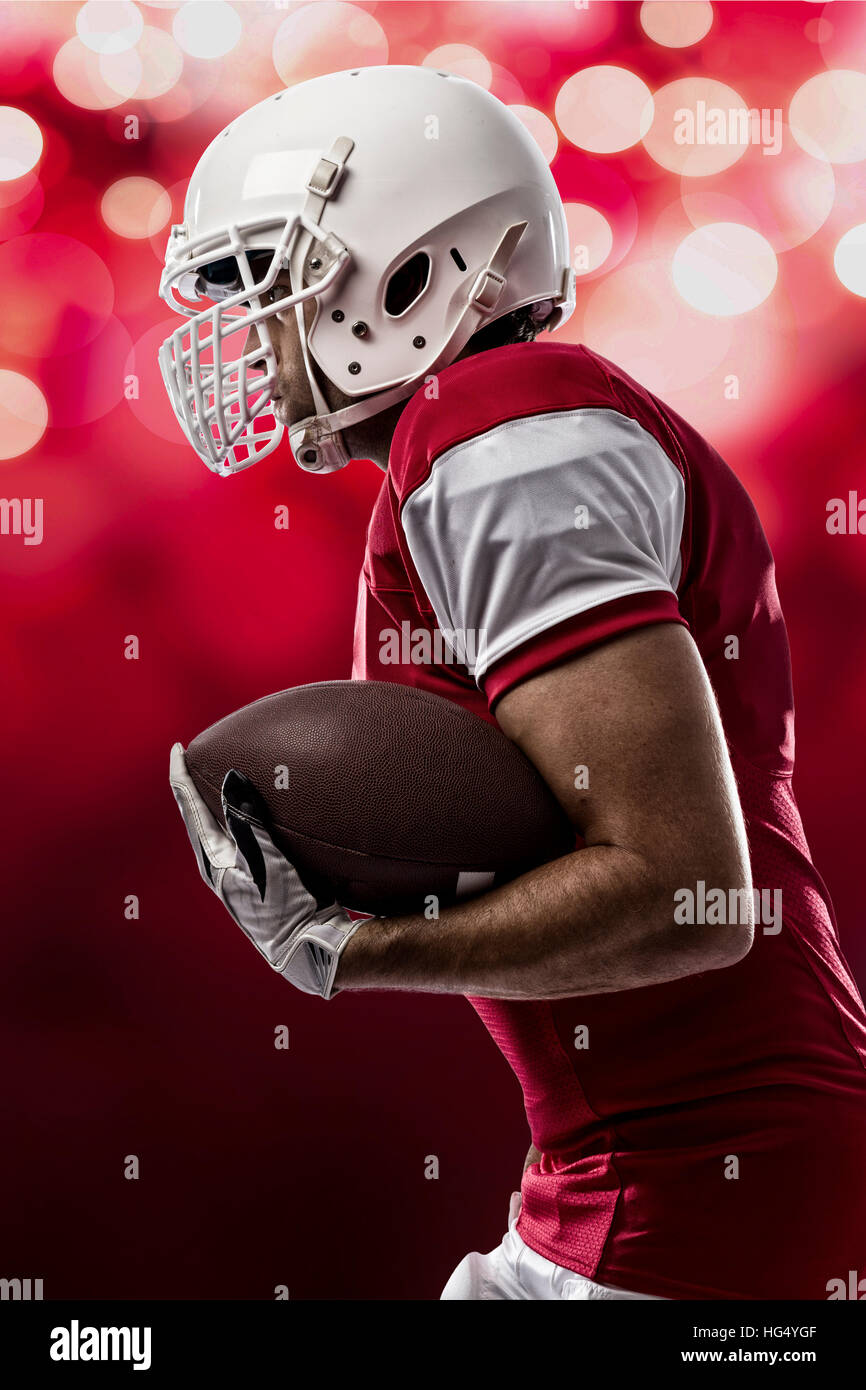 Football Player with a red uniform Running on a red lights background ...