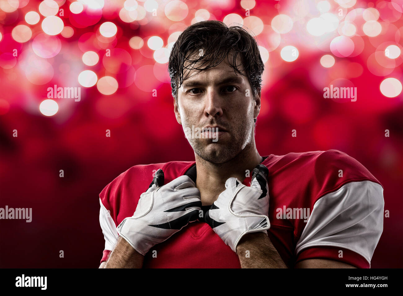 Football Player with a red uniform on a red lights background Stock ...