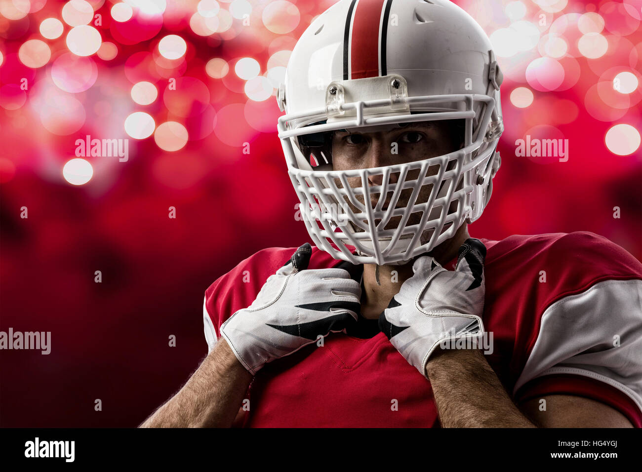 Football Player with a red uniform on a red lights background Stock ...