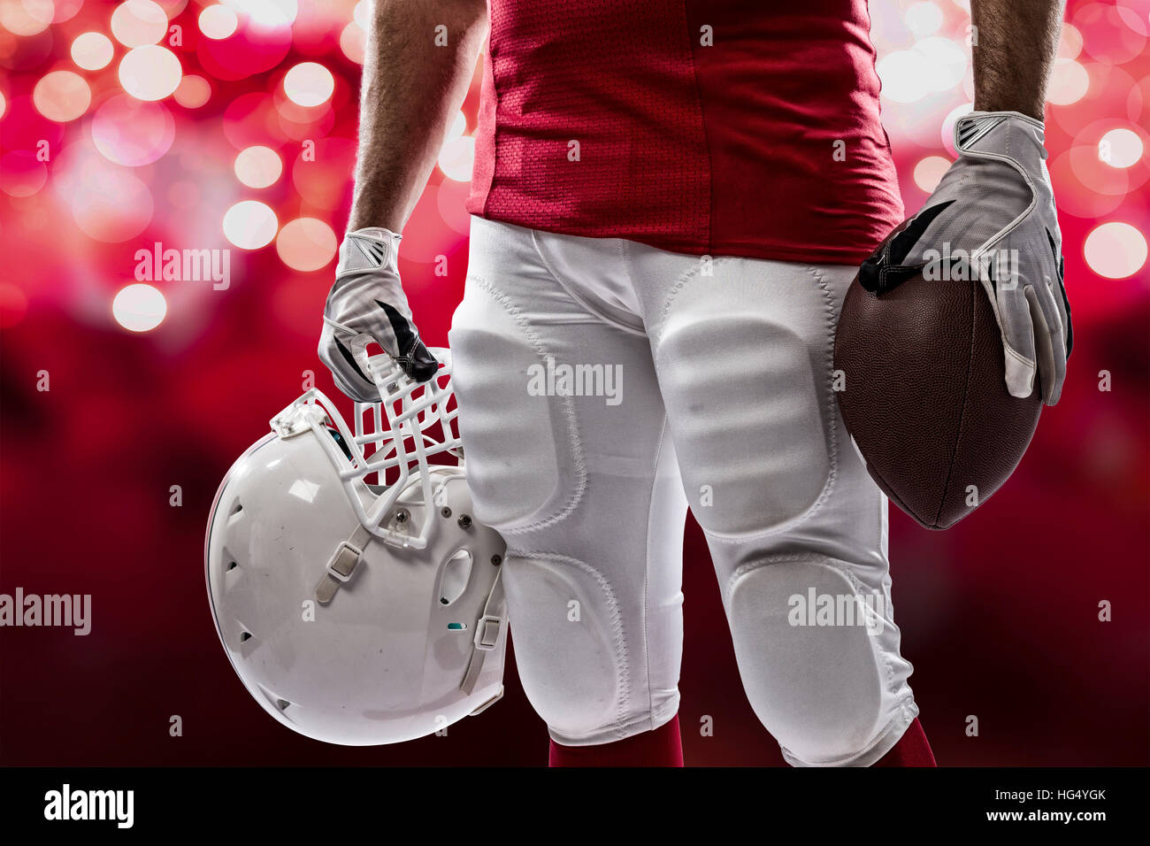 Football Player with a red uniform on a red lights background Stock ...