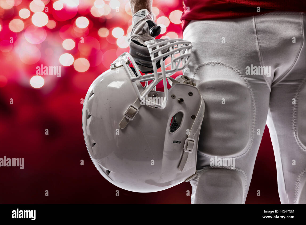 Football Player with a red uniform on a red lights background Stock ...