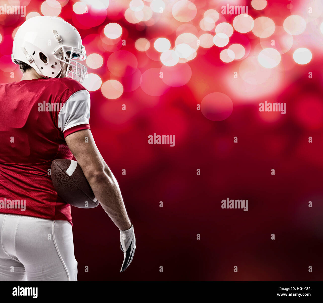 Football Player with a red uniform on a red lights background Stock ...