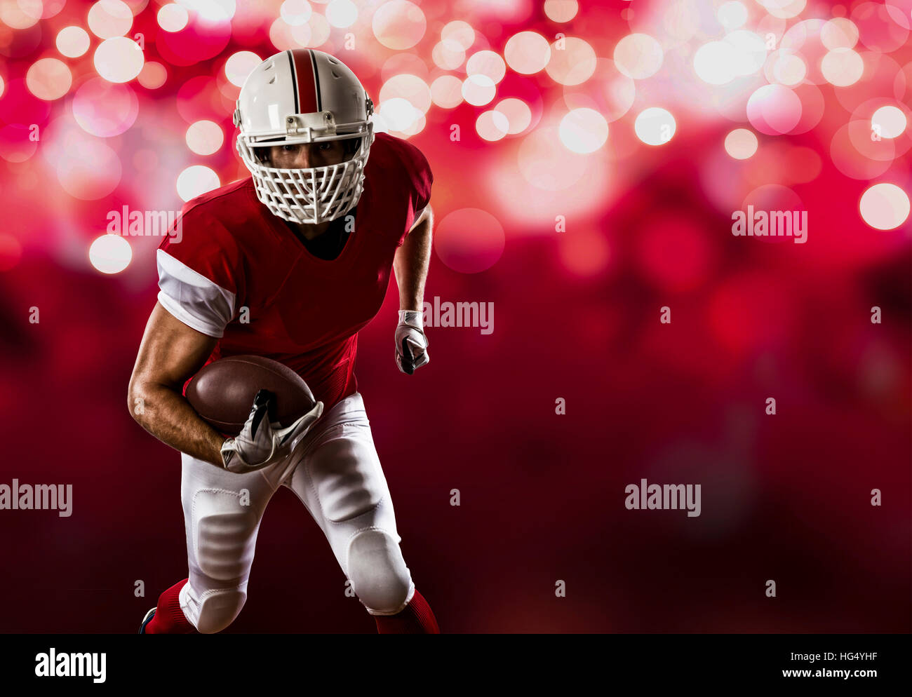 Football Player with a red uniform Running on a red lights background ...