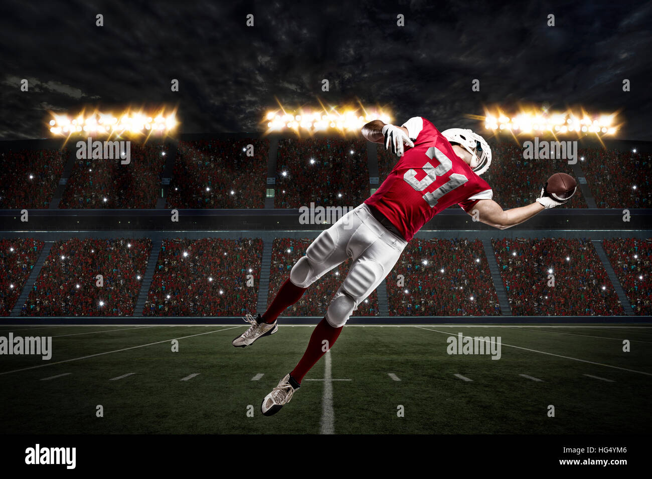 Football Player with a red uniform catching a ball on a stadium Stock ...