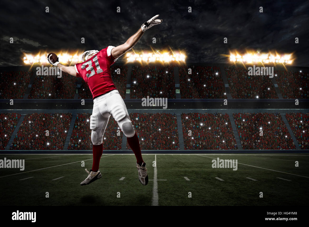 Football Player with a red uniform catching a ball on a stadium Stock ...