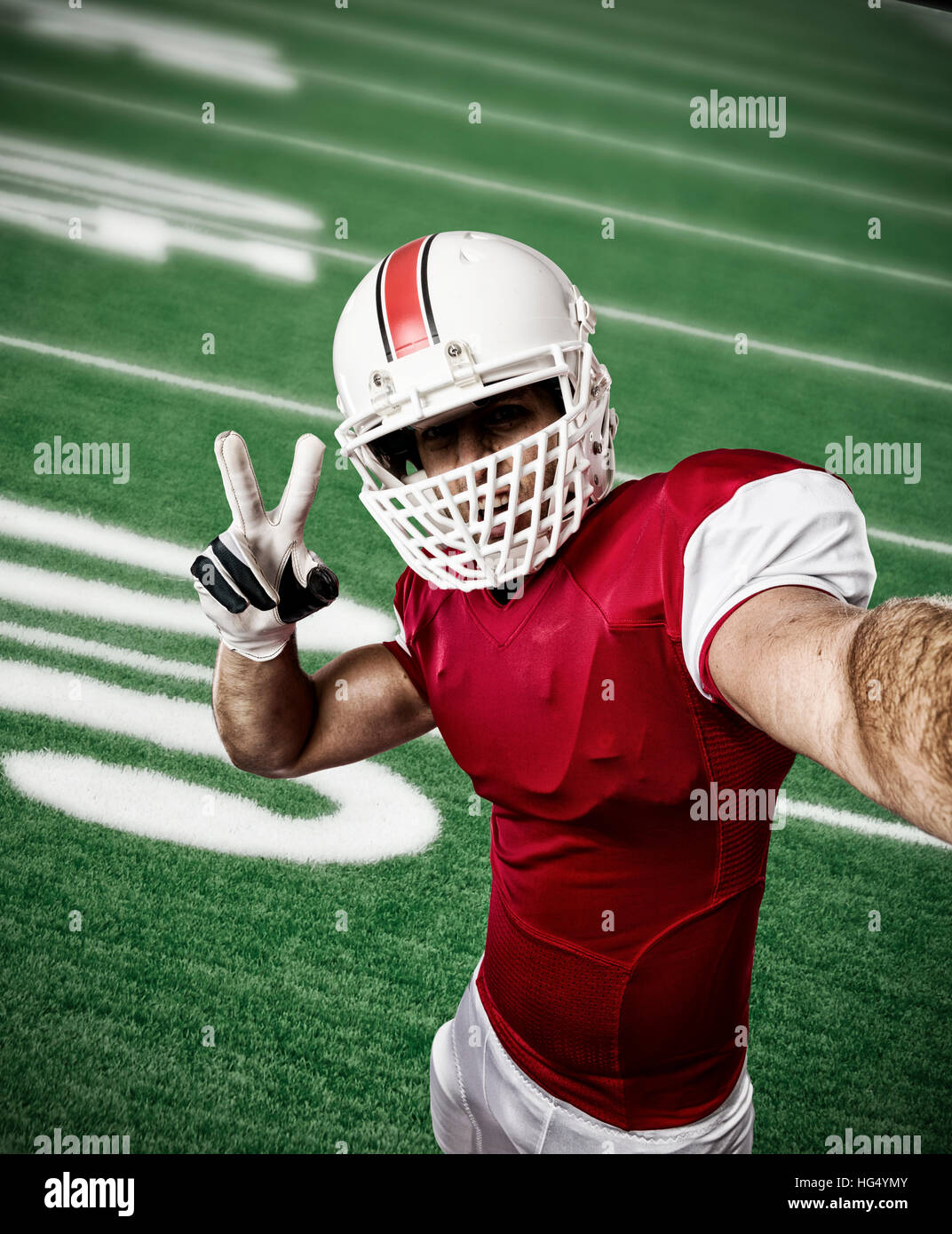 Football Player with a red uniform making a selfie on a football field ...