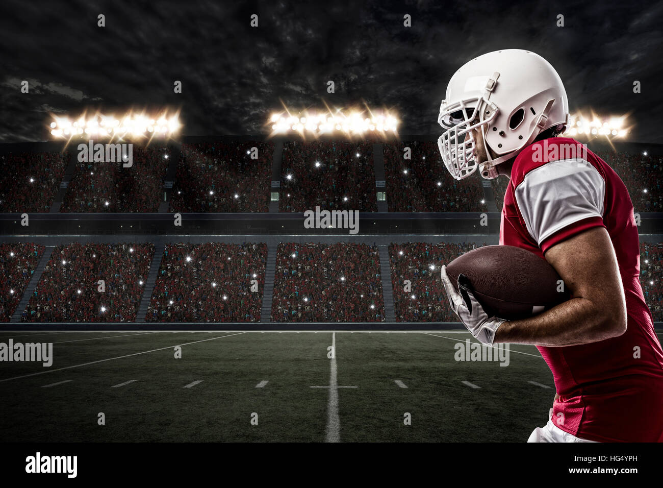 Football Player with a red uniform Running on a Stadium Stock Photo - Alamy