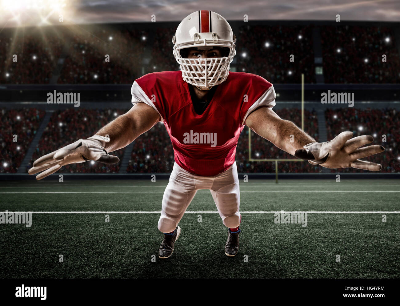 Football Player with a red uniform making a tackle on a stadium Stock ...