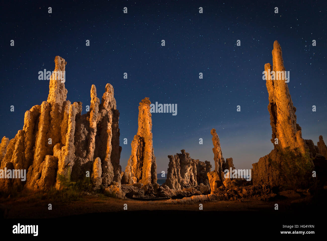 Tufa formation at Mono Lake at night with stars in the sky. Shallow ...