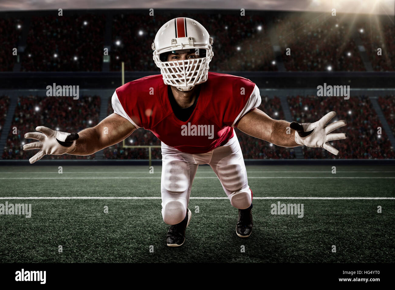 Football Player with a red uniform making a tackle on a stadium Stock ...