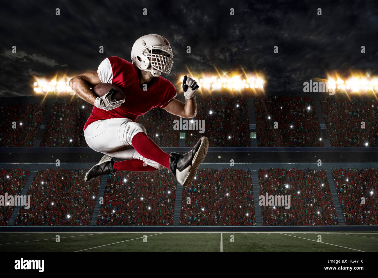 Football Player with a red uniform Running on a Stadium Stock Photo - Alamy
