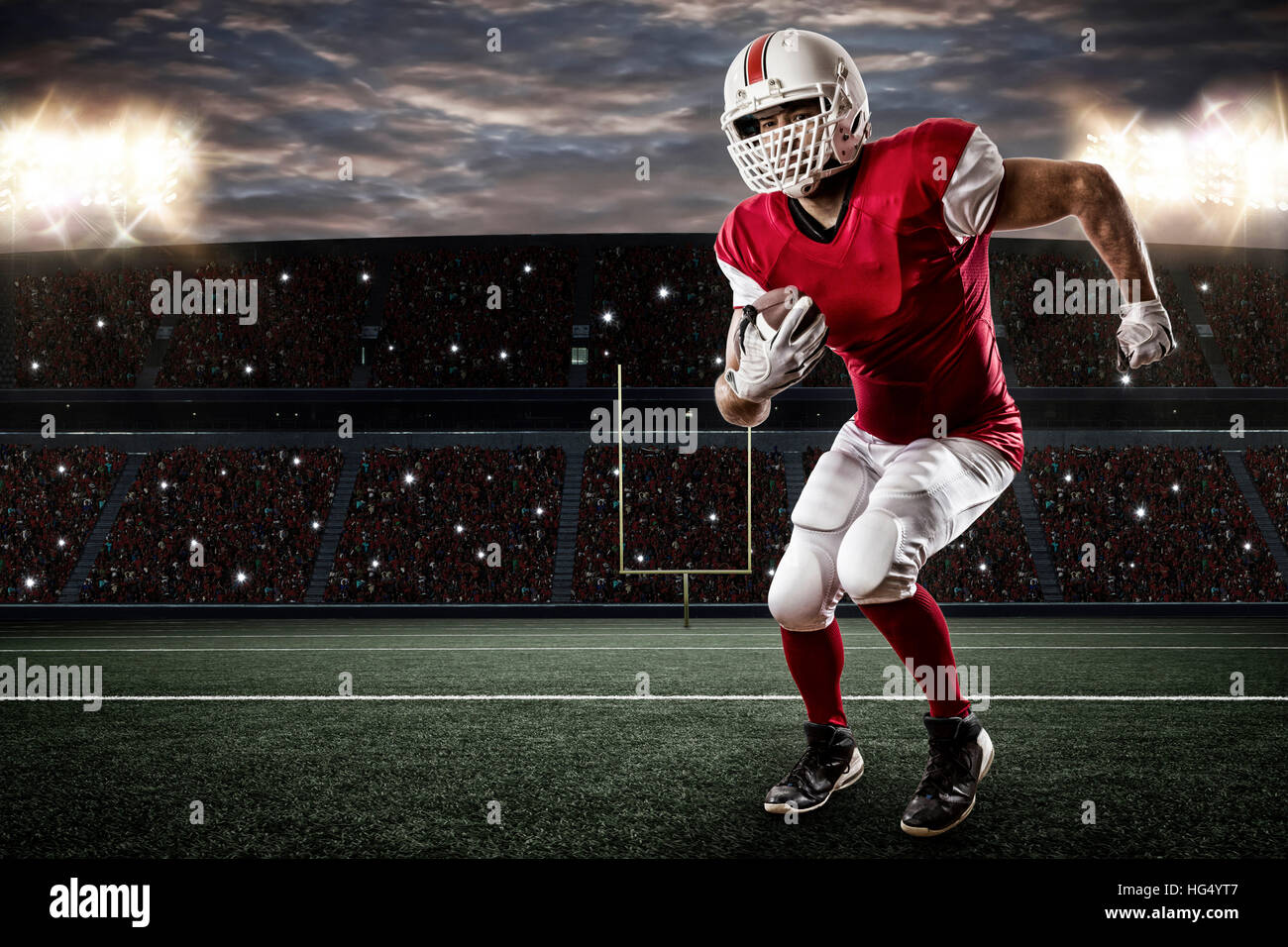 Football Player with a red uniform Running on a Stadium Stock Photo - Alamy