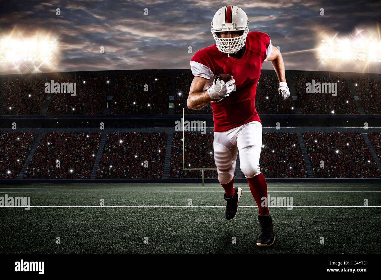 Football Player with a red uniform Running on a Stadium Stock Photo - Alamy