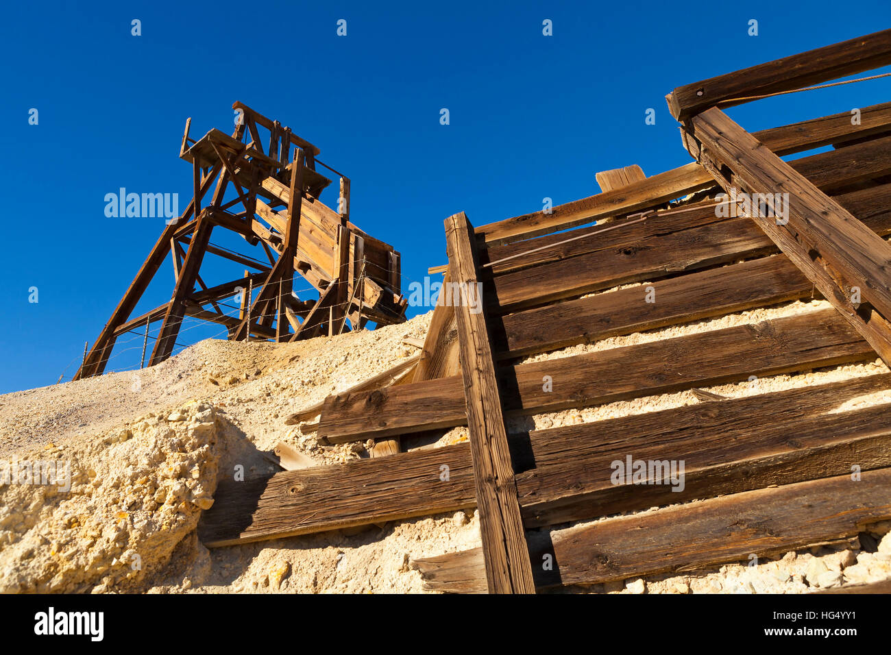 Old wooden mining hopper bin under blue sky in the Nevada Desert near a ...