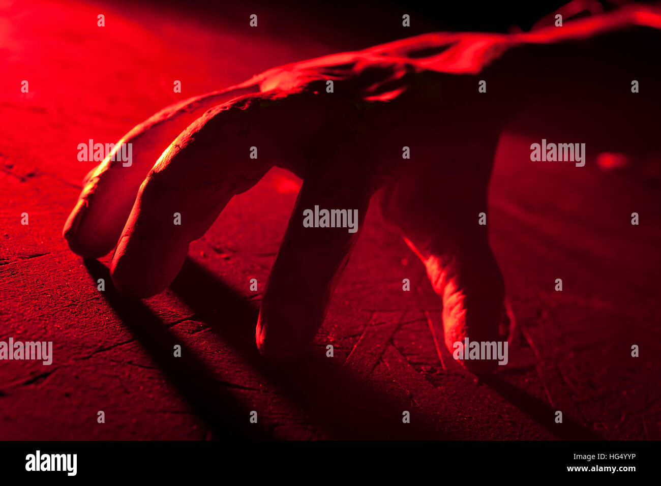 Creepy crawling hand in red light inside a haunted house. Halloween ...