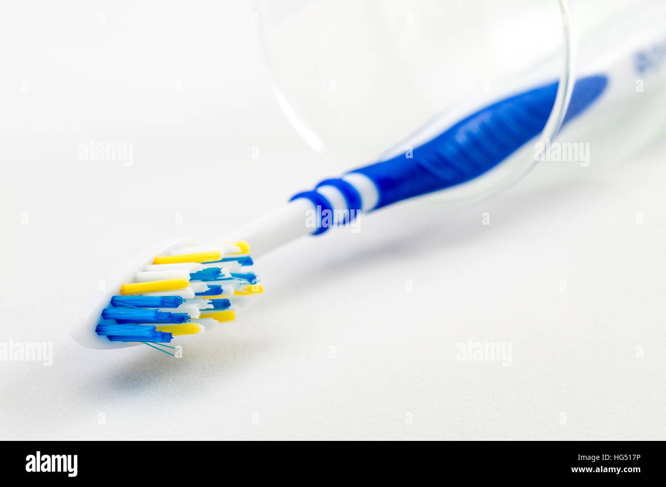 The new colorful toothbrush in a glass Stock Photo - Alamy