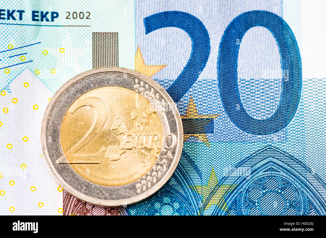 Detail of two euro coin on blue twenty euro banknote background Stock ...