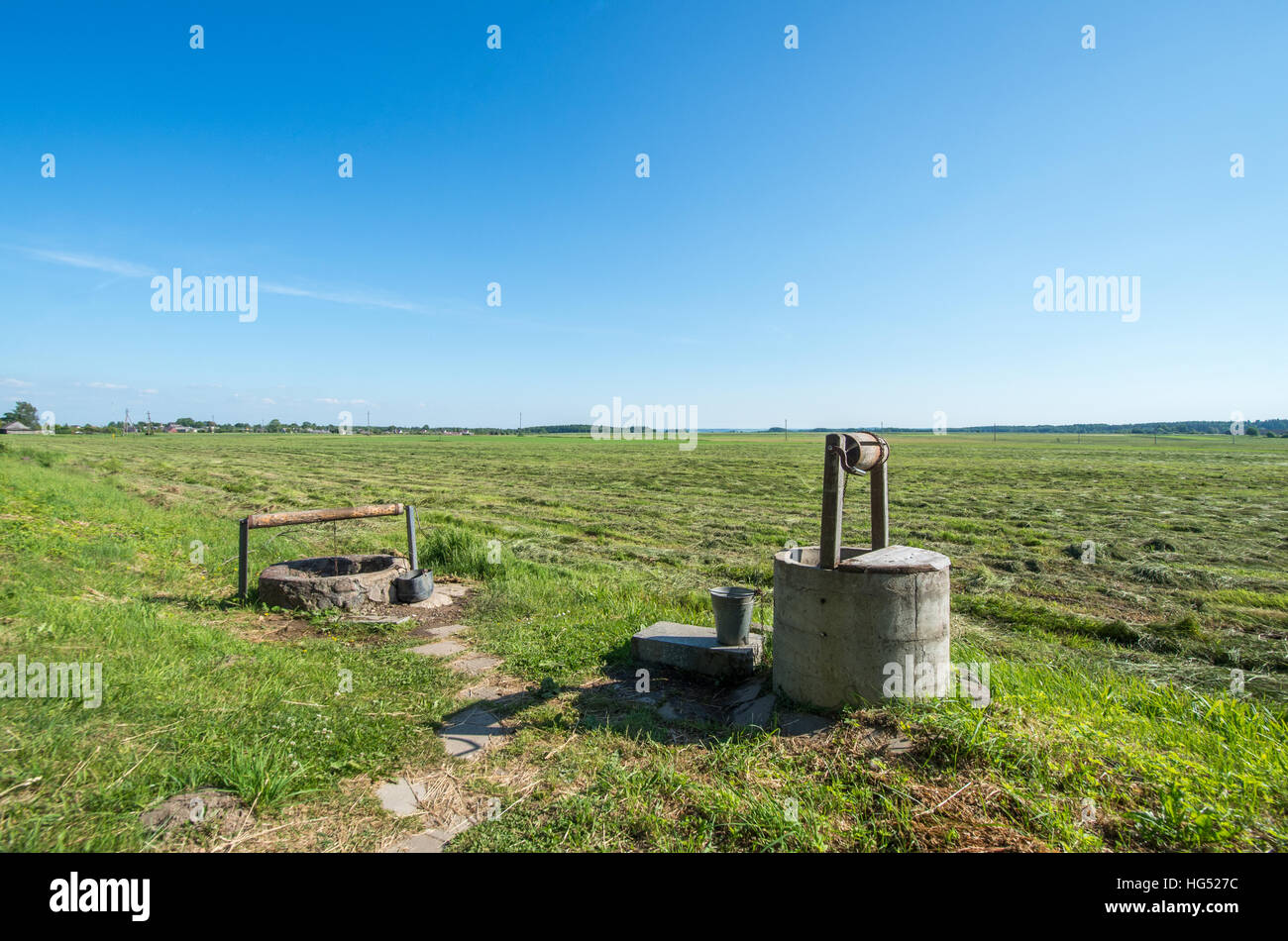 A typical rural picture with two wells Stock Photo - Alamy