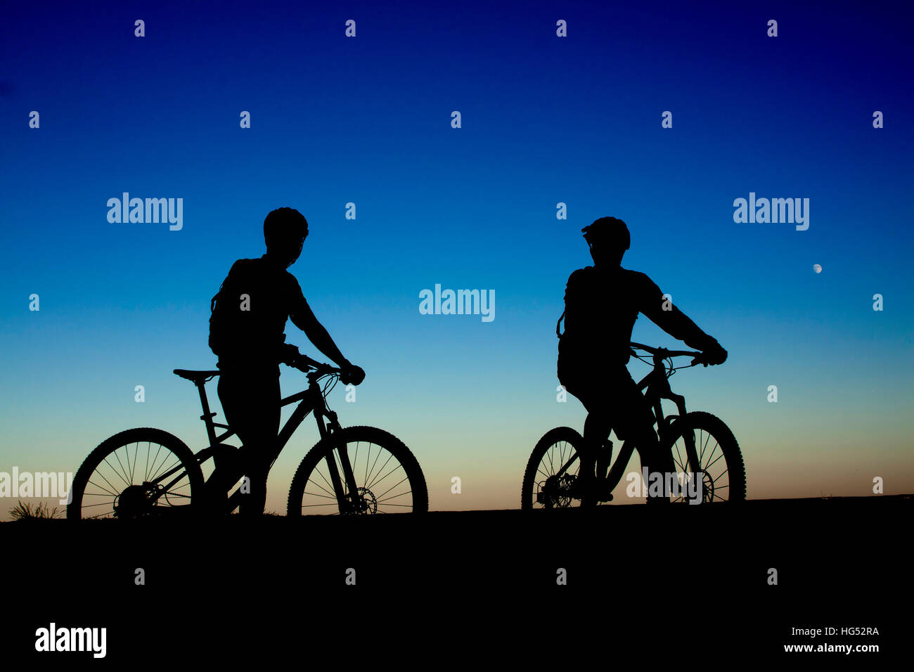 Two cyclists on the background of night sky and moon Stock Photo - Alamy