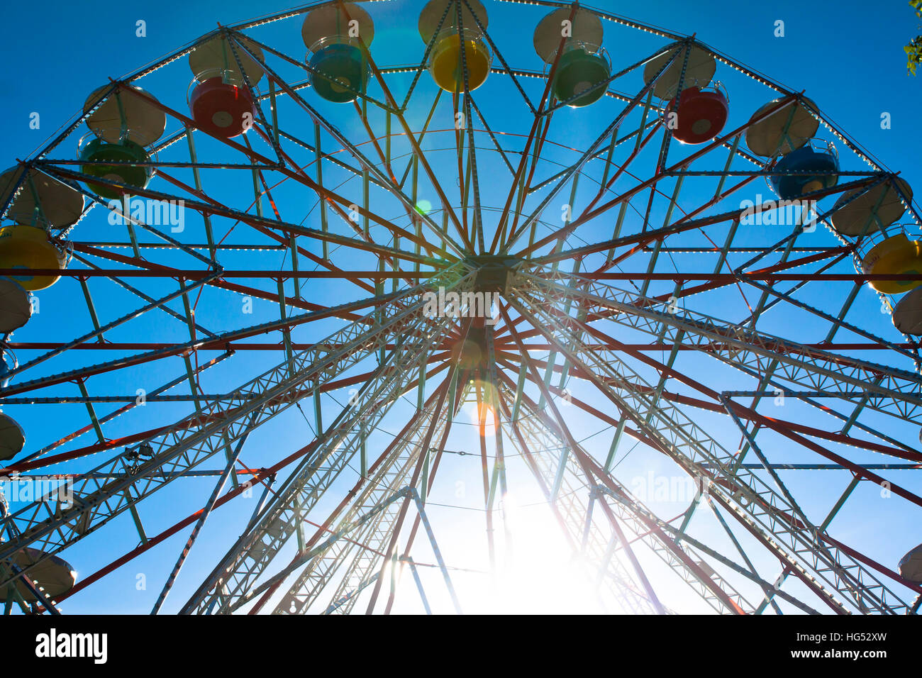 Ferris wheel in an amusement park on sun background Stock Photo - Alamy