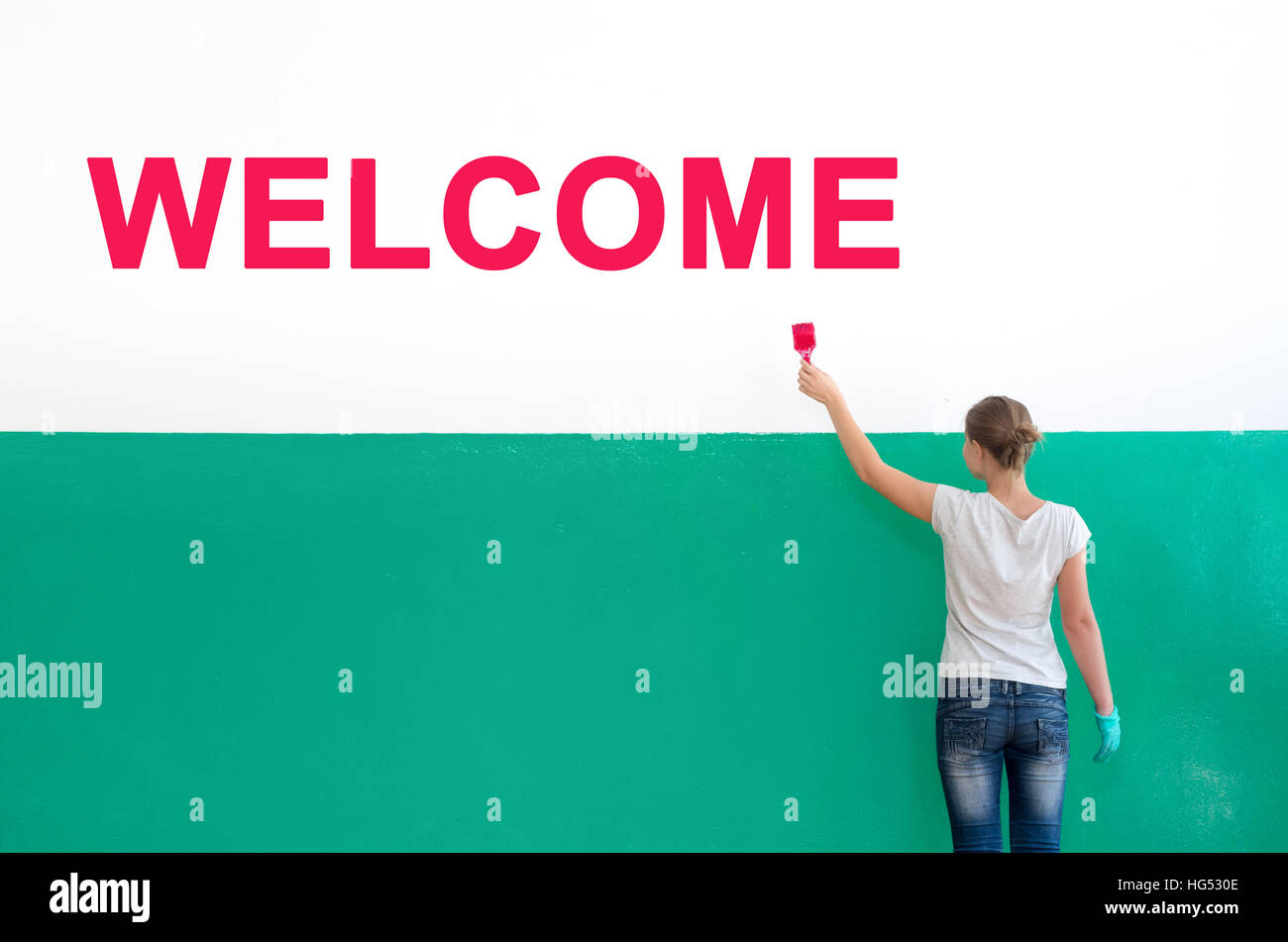 On the white wall with paint write Welcome Stock Photo - Alamy