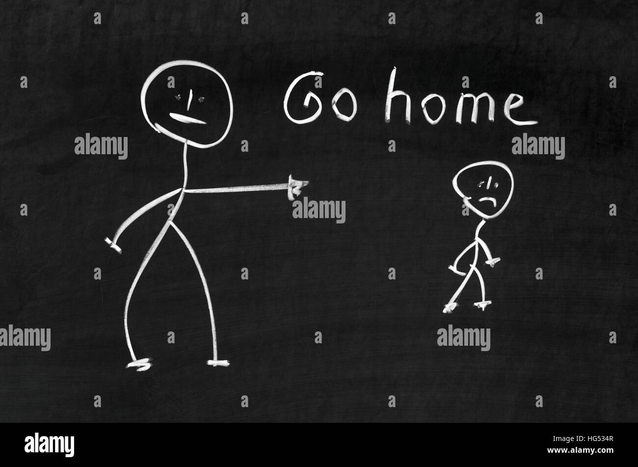 Dark chalkboard with two characters and write Go home Stock Photo - Alamy