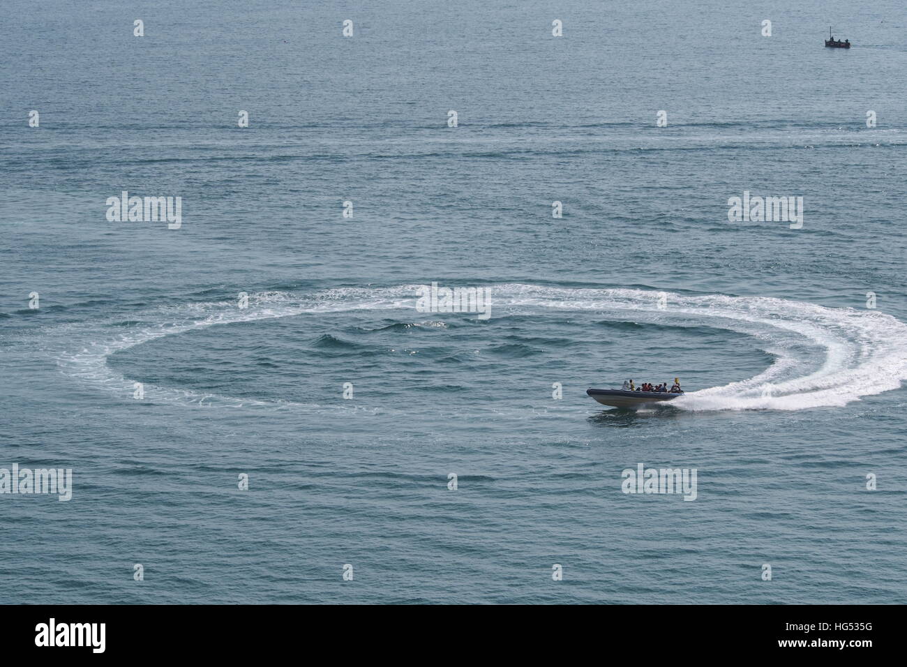 Rigid inflatable boat circling Stock Photo - Alamy