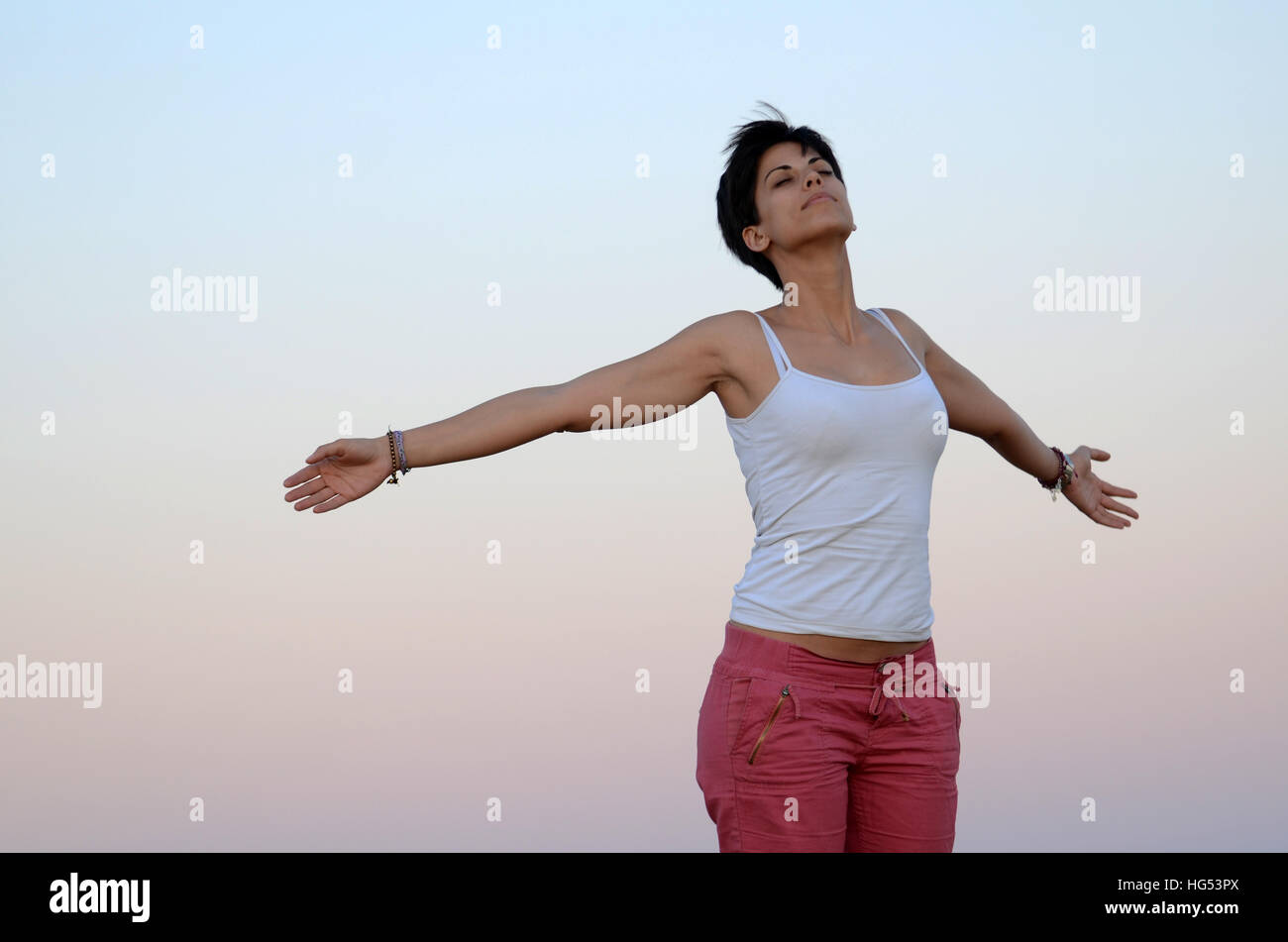 Attractive young woman relaxes in nature with arms wide open Stock ...