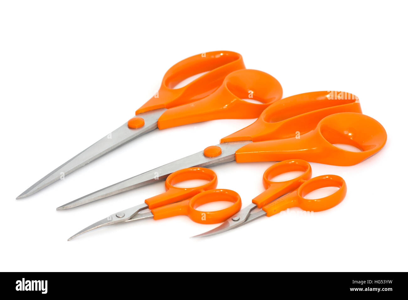 Four scissors with orange handles on a white background Stock Photo - Alamy